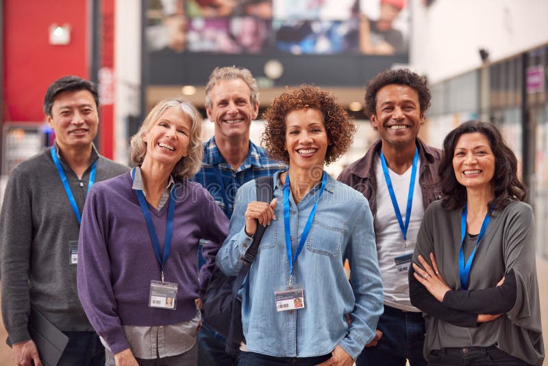 Portrait of Group of Smiling Mature Students Standing in College Hall ...