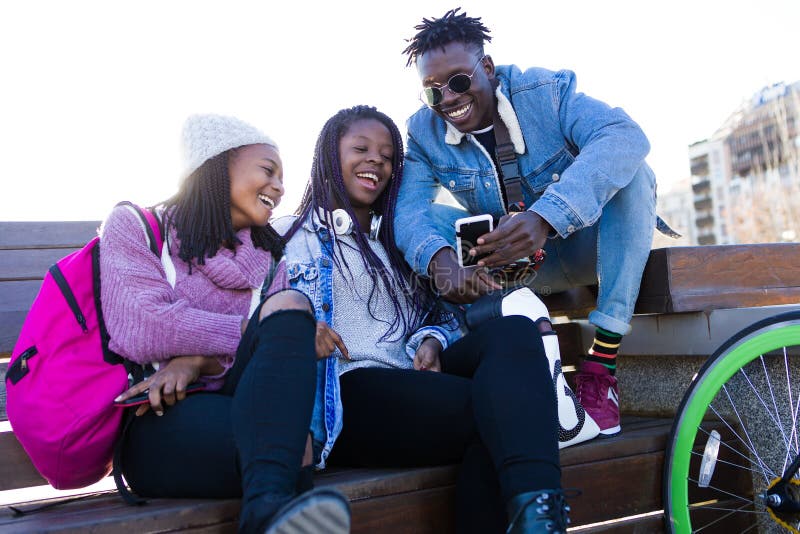 Group of Three Friends Using Mobile Phone in the Street. Stock Image ...