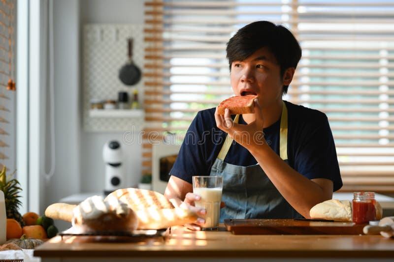 Portrait of Handsome Asian Man Eating a Fresh Slice of Bread with Jam ...
