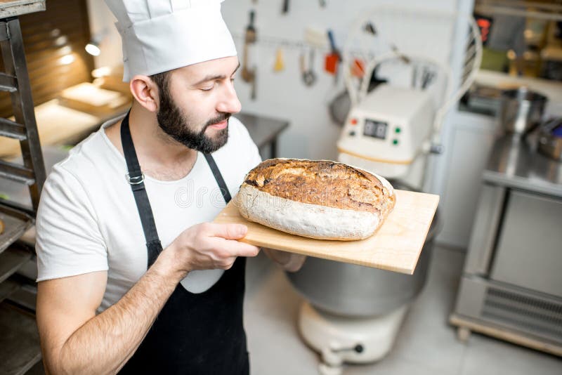 Baker with Bread in the Bakery Stock Photo - Image of delicious, baker ...