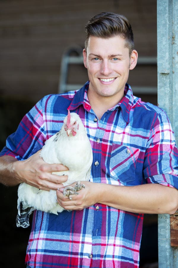 Handsome Blond Man Holding a White Chicken Stock Image - Image of ...