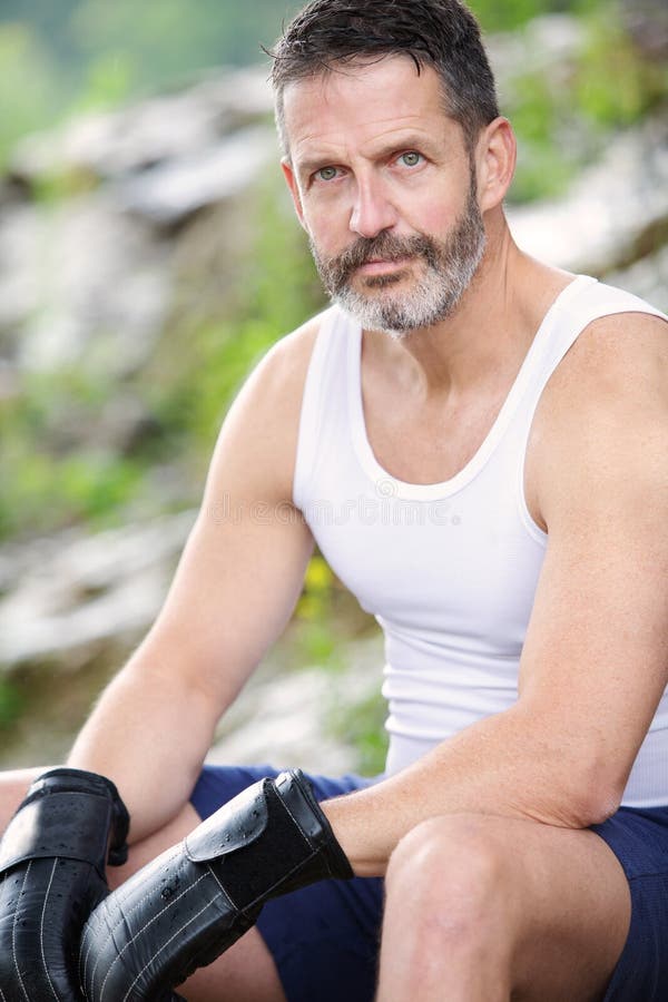 Handsome Boxer Sitting Outdoors Taking a Break Stock Photo - Image of ...
