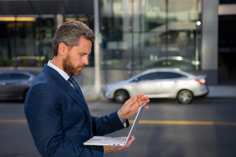 Portrait of Handsome Business Man Using Laptop Outdoor. Stock Photo ...