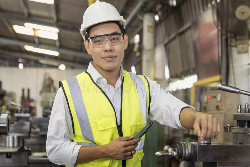 Portrait of an Handsome Engineer in a Factory. Asian Mechanical ...