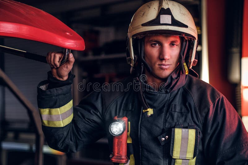Portrait of a Handsome Fireman Wearing a Protective Uniform with ...