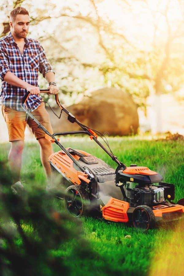 Gardener - Worker in Working Clothes, Watering Plants with Watering Can ...