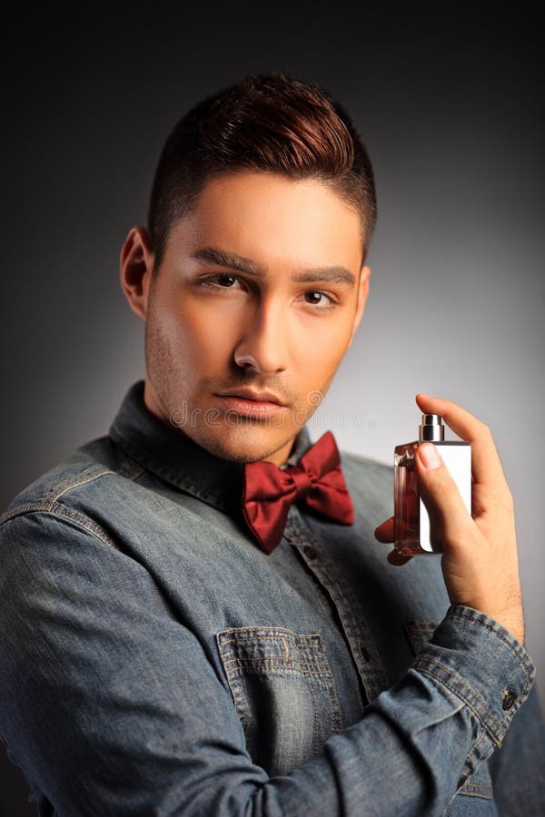 A Portrait Of A Handsome Male Applying Perfume Stock Photo - Image of ...
