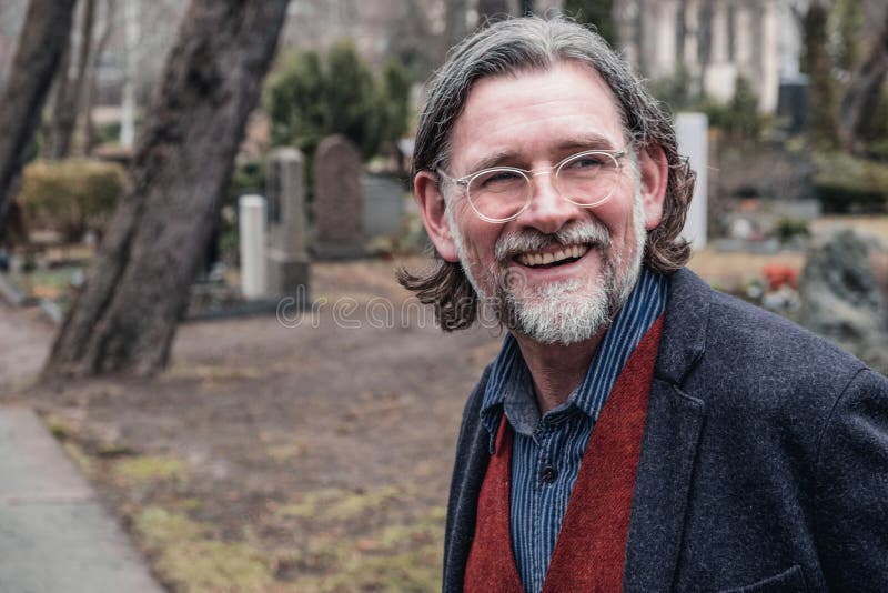 Handsome Man in His 50s in Cemetery Outside Smiling Stock Photo - Image ...