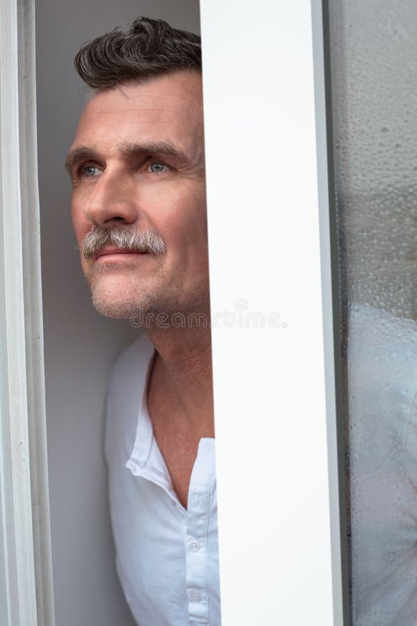 Portrait of Handsome Man in His 50s Standing by Window Stock Photo ...