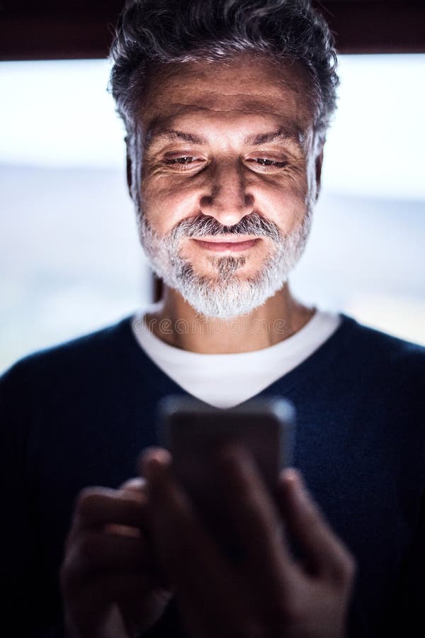 Portrait of Handsome Man Looking at Smartphone Screen. Display Glow ...