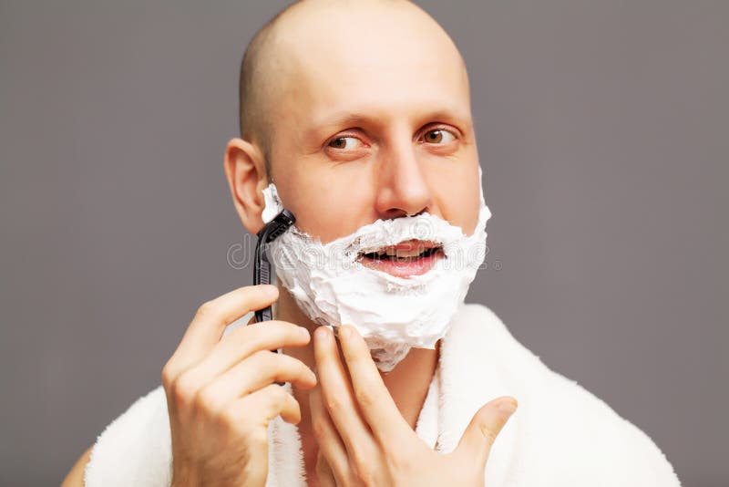 Portrait of Handsome Man Shaving Using a Razor and Looking Away Stock ...