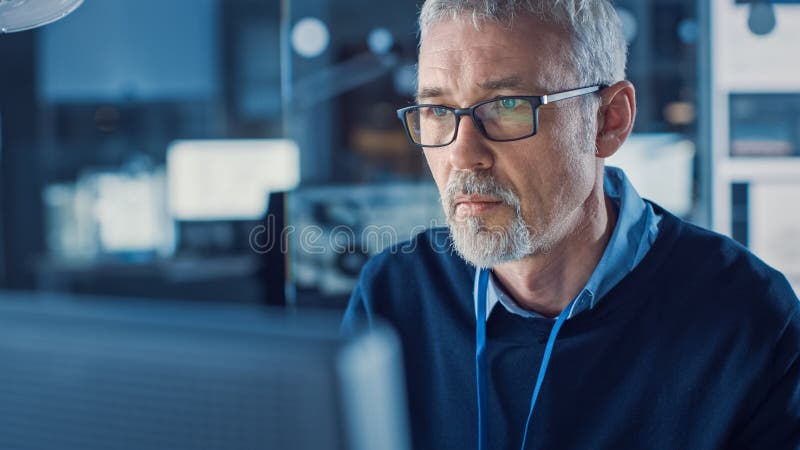 Portrait of Handsome Middle Aged Engineer Wearing Glasses Works on ...