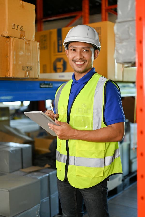 Handsome Asian Warehouse Worker Smiling, Looking at Camera while ...