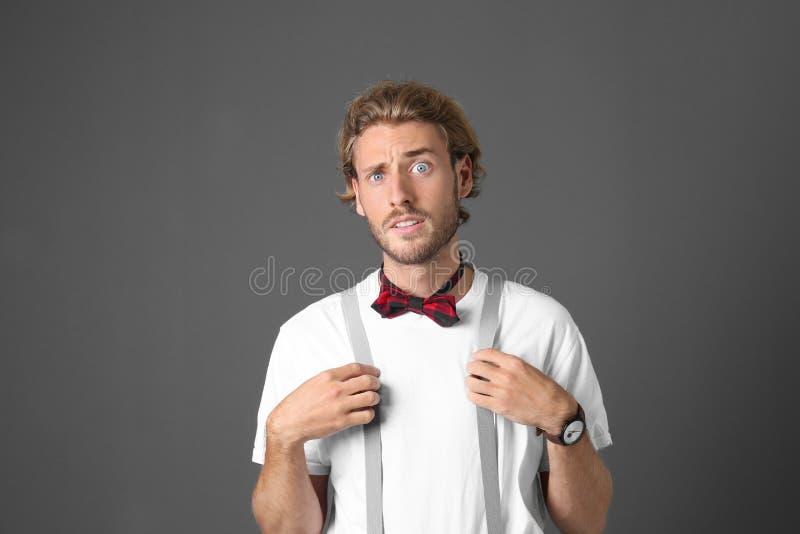 Portrait of Mistrustful Puzzled Young Man in Casual Clothes Holding ...