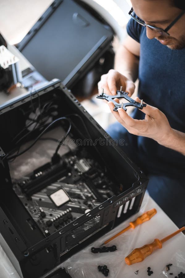 Handsome Nerd Man is Servicing Computer Motherboard and Cooler. Stock ...