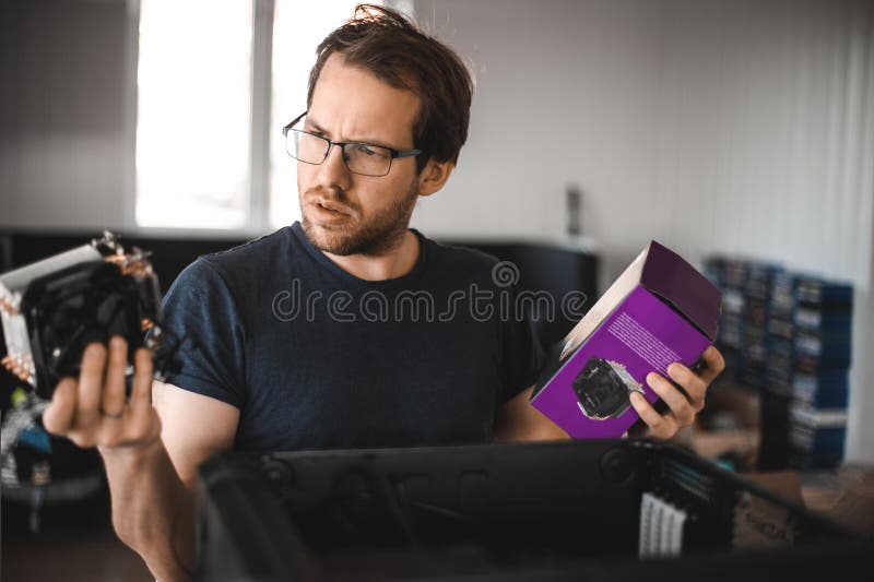 Handsome Nerd Man is Servicing Computer Motherboard and Cooler. Stock ...
