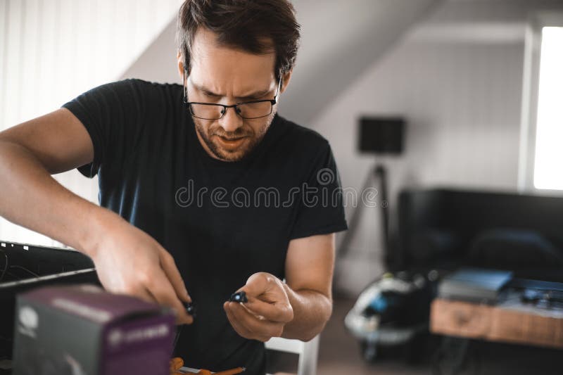 Handsome Nerd Man is Servicing Computer Motherboard and Cooler. Stock ...