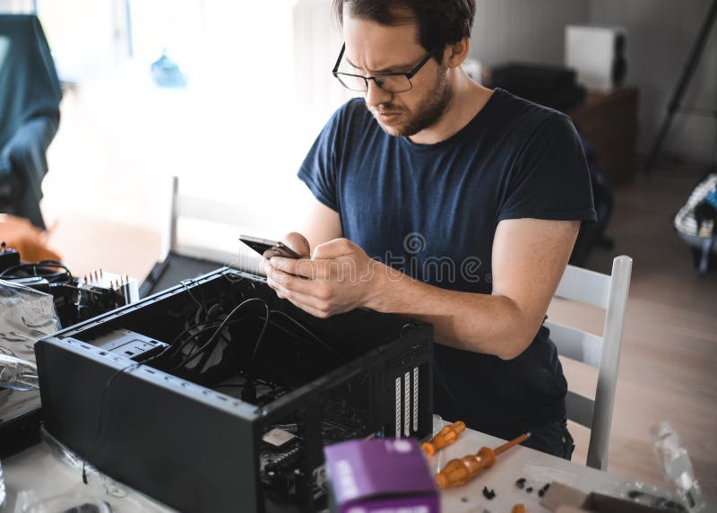 Handsome Nerd Man is Servicing Computer Motherboard and Cooler. Stock ...