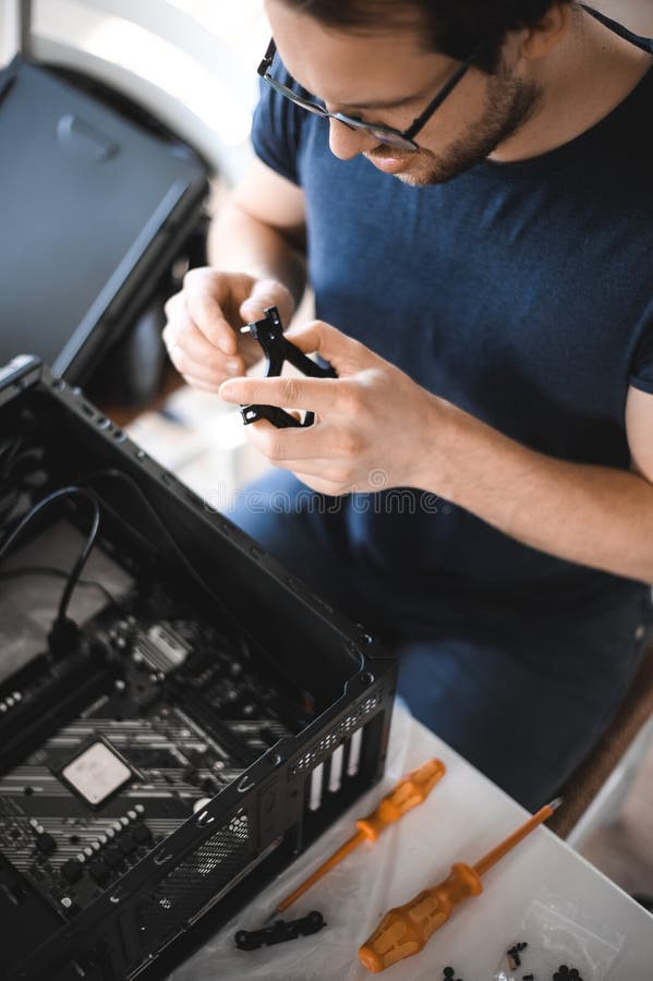 Handsome Nerd Man is Servicing Computer Motherboard and Cooler. Stock ...