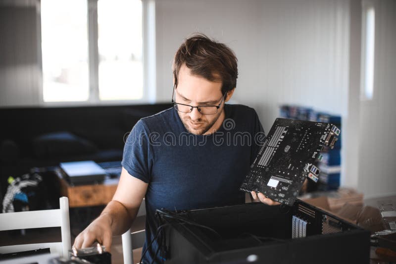 Handsome Nerd Man is Servicing Computer Motherboard and Cooler. Stock ...