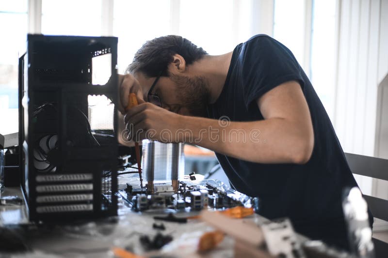 Handsome Nerd Man is Servicing Computer Motherboard and Cooler. Stock ...