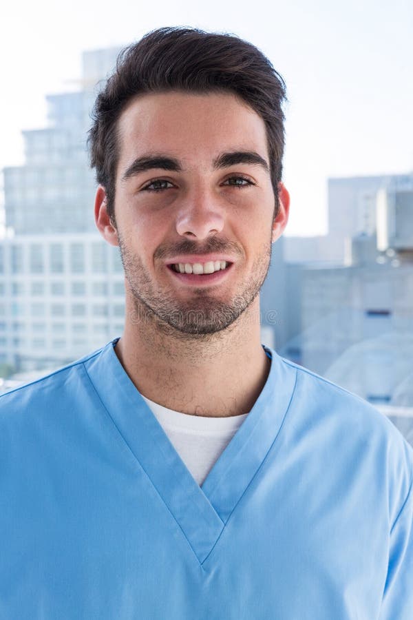 Handsome Surgeon in Blue Scrubs Using Stethoscope Stock Photo - Image ...