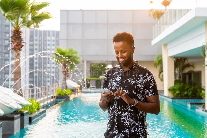 Portrait of Handsome Young African Man Using Mobile Phone Stock Image ...