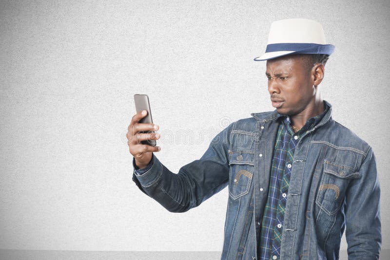 Portrait of a Handsome Young African Man Standing with a Mobile Stock ...