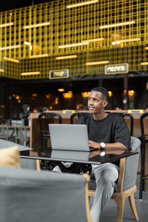 Portrait of Handsome Young African Man Using Laptop Computer in Coffee ...