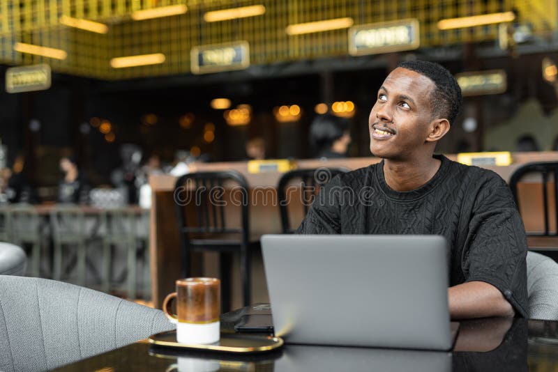 Portrait of Handsome Young African Man Using Laptop Computer in Coffee ...
