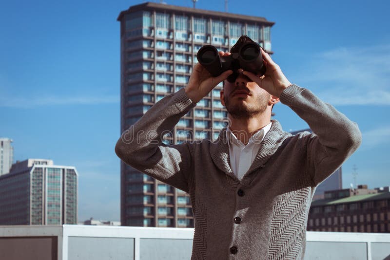 Portrait of a Handsome Young Man Looking through Binoculars Stock Photo ...