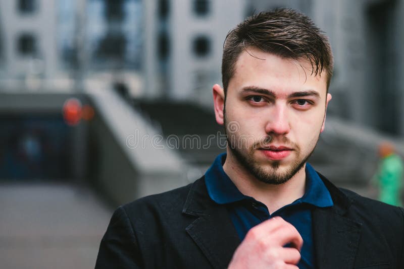 Portrait of a Handsome Young Man Looking into the Camera Against the ...