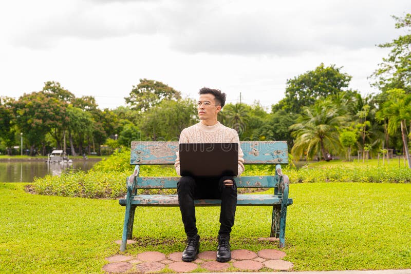 Portrait of Handsome Young Man in Park during Summer Using Laptop ...