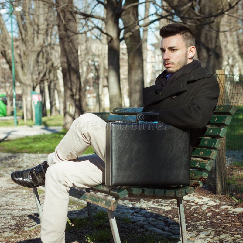 Portrait of a Handsome Young Man Sitting on a Bench Stock Image - Image ...