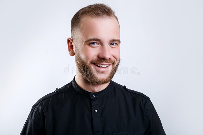 Portrait of a Handsome Young Man Smiling on Gray Background Stock Photo ...