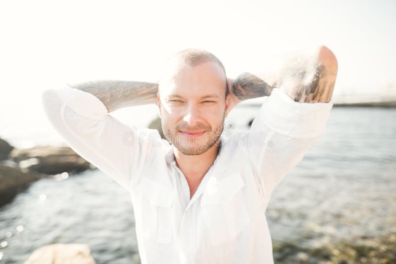 Portrait of a Handsome Young Man in the Sun by the Sea Stock Photo ...
