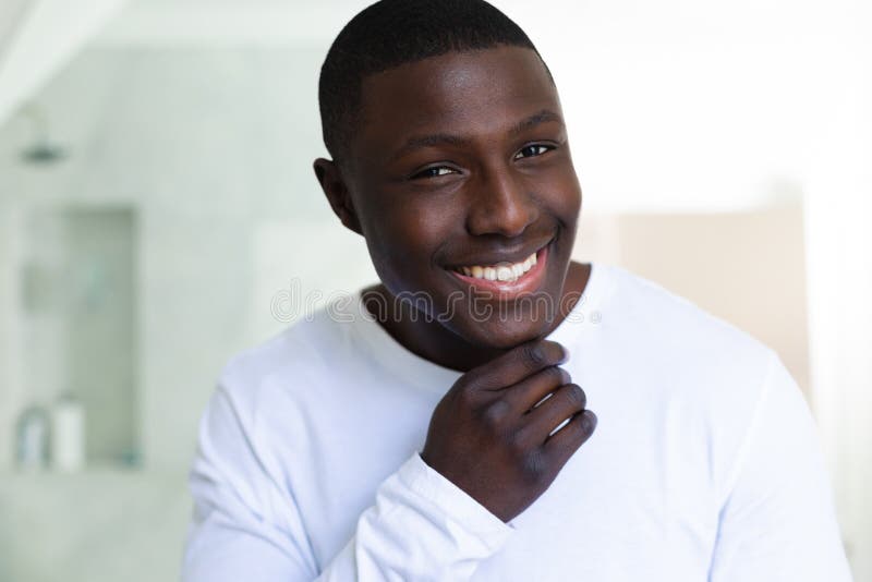 Portrait Of Happy African American Man Smiling To Camera In Bathroom