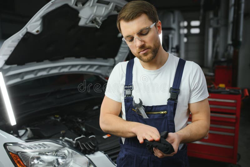 Portrait of a Happy Auto Mechanic Cleaning Hands with Cloth Stock Photo ...