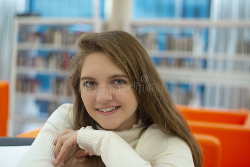 Portrait of Happy Beautiful Young Student. she is Reading in a Modern ...