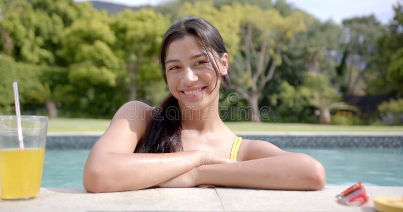 Portrait of Happy Biracial Teenage Girl Standing in Sunny Swimming Pool ... Portrait of Happy Biracial Teenage Girl Standing in Sunny Swimming Pool ...