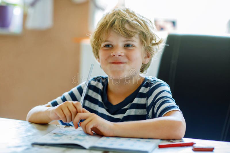 Portrait of Happy Boy Doing Homework in Kitchen at Home. Elementary ...