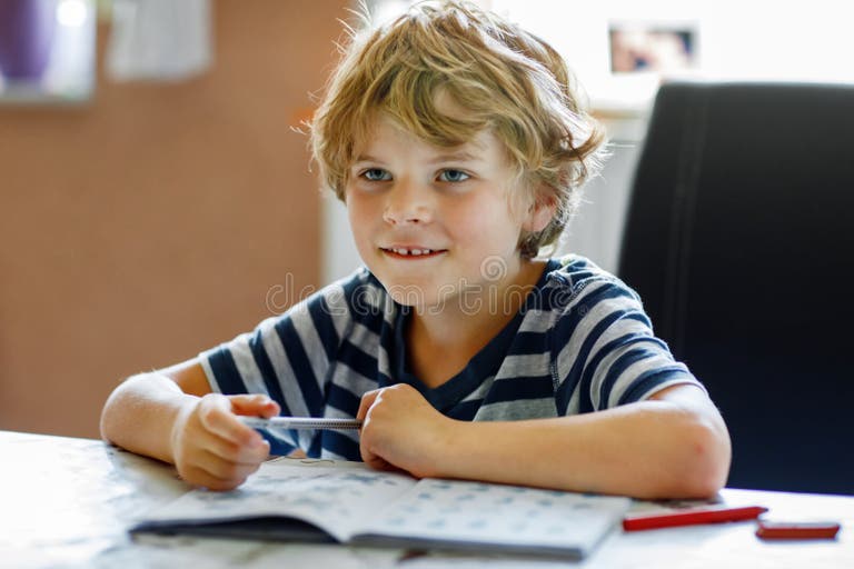 Portrait of Happy Boy Doing Homework in Kitchen at Home. Elementary ...
