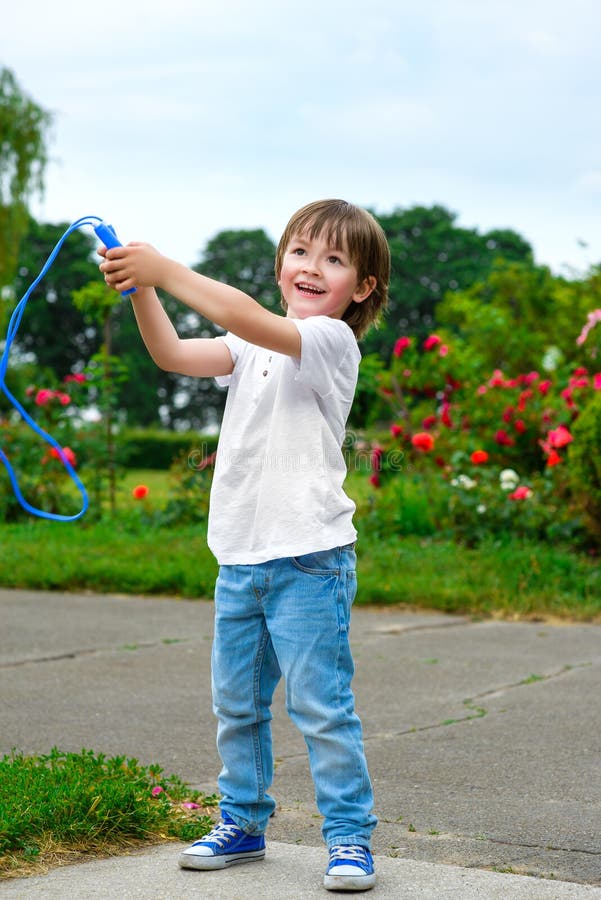 Portrait of Happy Boy Holding Skipping Rope Stock Photo - Image of ...