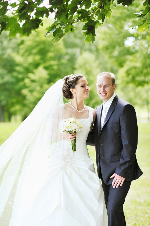 Happy Bride and Groom in a Park Stock Photo - Image of fashion ...