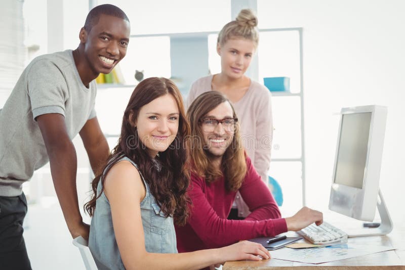 Portrait of Happy Business Team Working at Computer Desk Stock Photo ...
