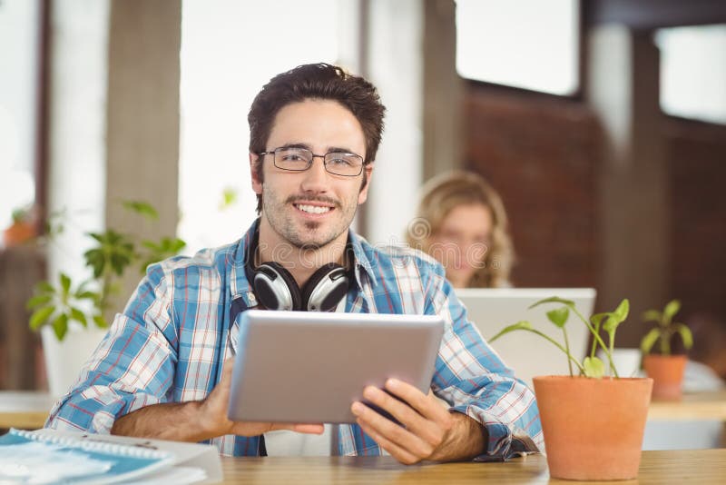 Portrait Of Happy Businessman Wearing Eye Glasses In Creative Office