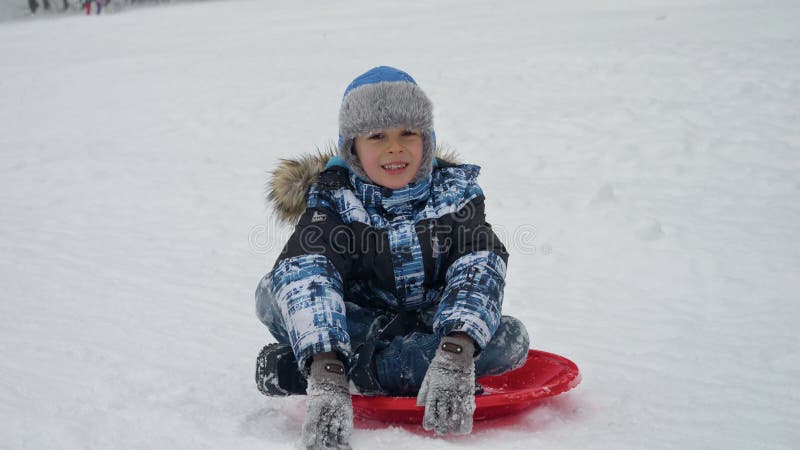 Portrait of Happy Cheerful Boy Sitting on Plastic Sleds and Smiling in ...