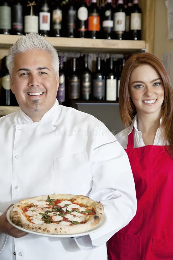 Portrait of a Happy Chef Holding Pizza with Wait Staff Stock Image ...