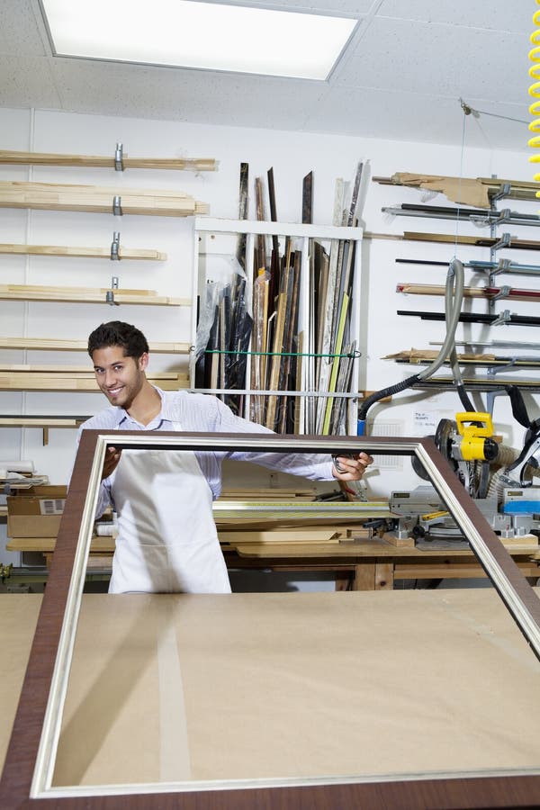 Portrait of a Happy Craftsman Working on Picture Frame in Workshop ...