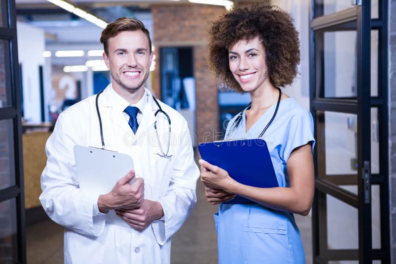Portrait of Happy Doctors Standing with Clipboard Stock Image - Image ...